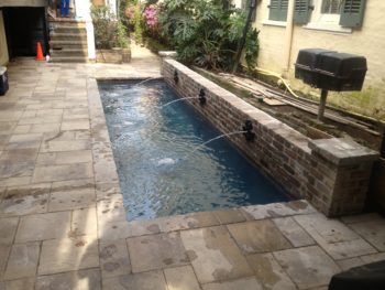 Cocktail pool with spa jets and raised brick wall - Crystal Pools and Spas