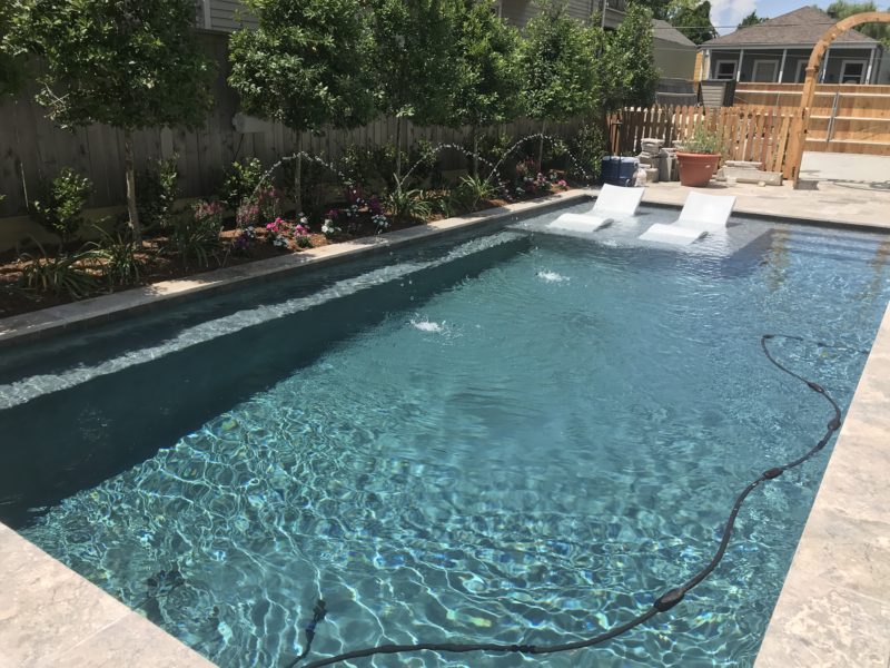 Uptown swimming pool with silver travertine - Crystal Pools and Spas